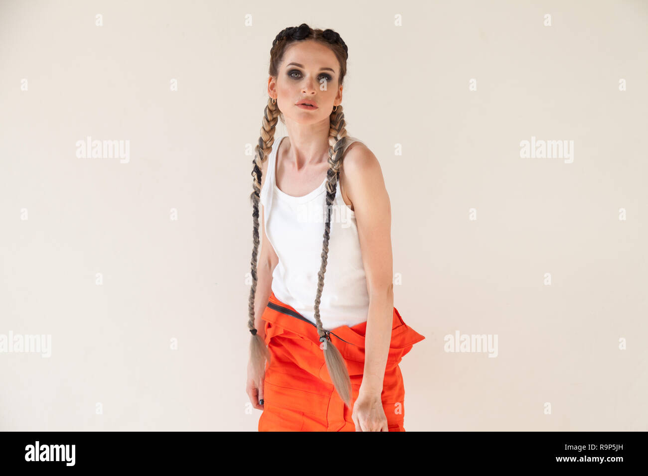 Beautiful Fashionable Woman With Braids Dancing Work Overalls Stock