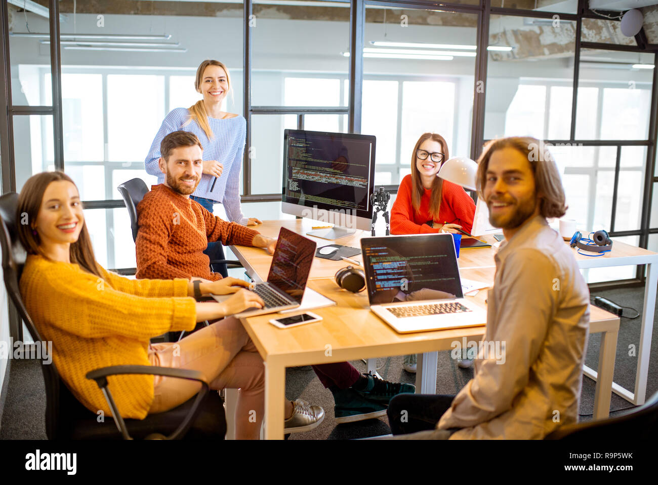 Portrait of a group of young programmers dressed casually working on ... Portrait of a group of young programmers dressed casually working on ...