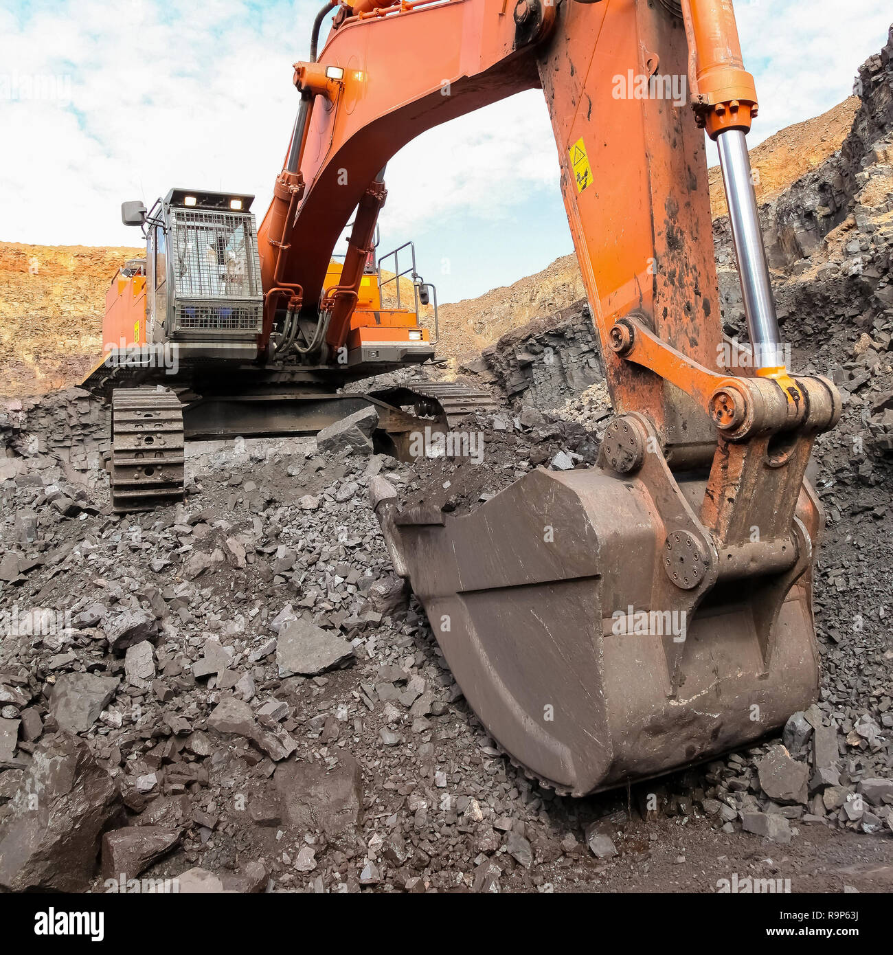 Excavator digging and loading ore rocks on a Manganese mine Stock Photo ...