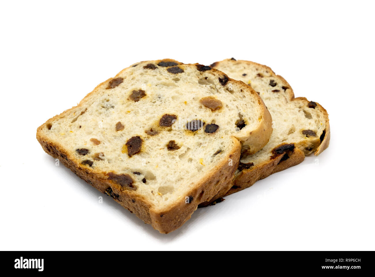 Two Slices of Freshly Cooked Fruit Bread lying flat on a white ...