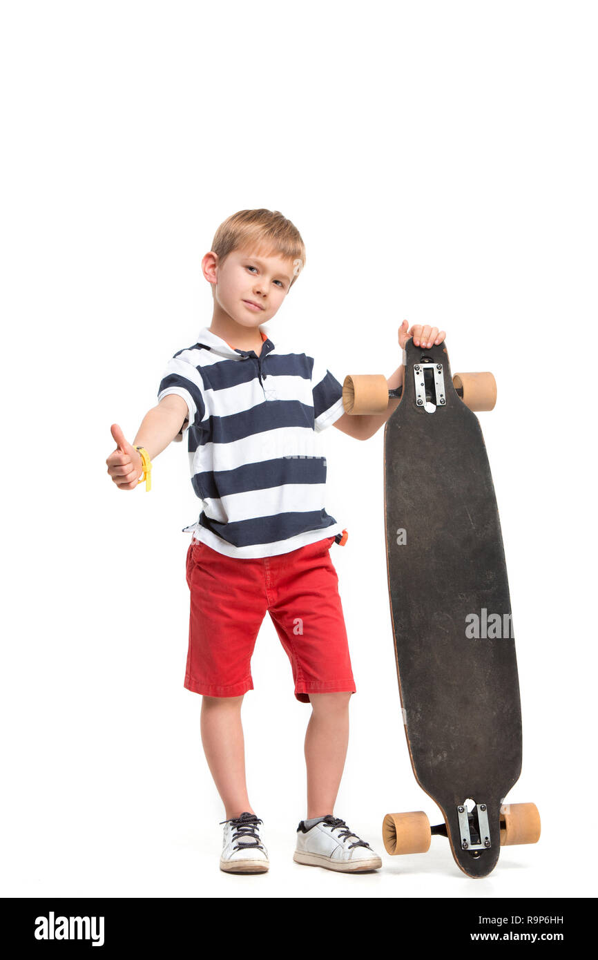 Full length portrait of an adorable young boy riding a skateboard ...