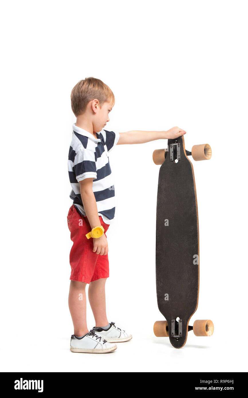 Full length portrait of an adorable young boy riding a skateboard ...