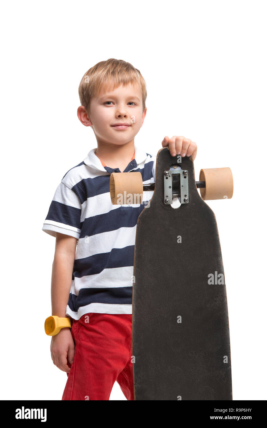 Full length portrait of an adorable young boy riding a skateboard ...