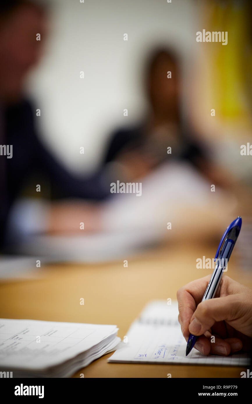Writing notes in a school note book line paper homework at a desk Stock ...