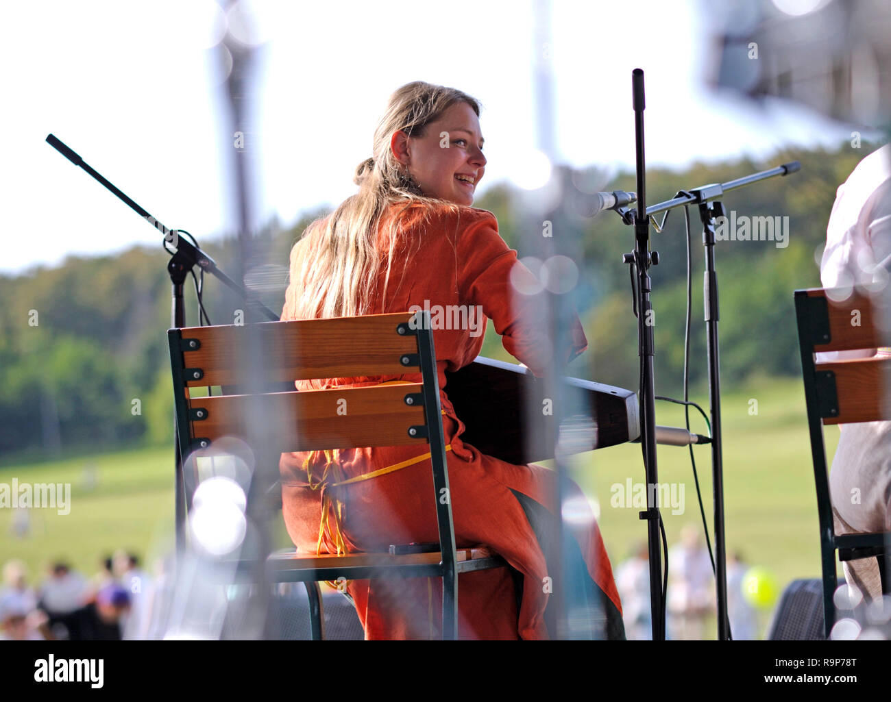 Woman in a native Latvian dress playing national musical instrument ...
