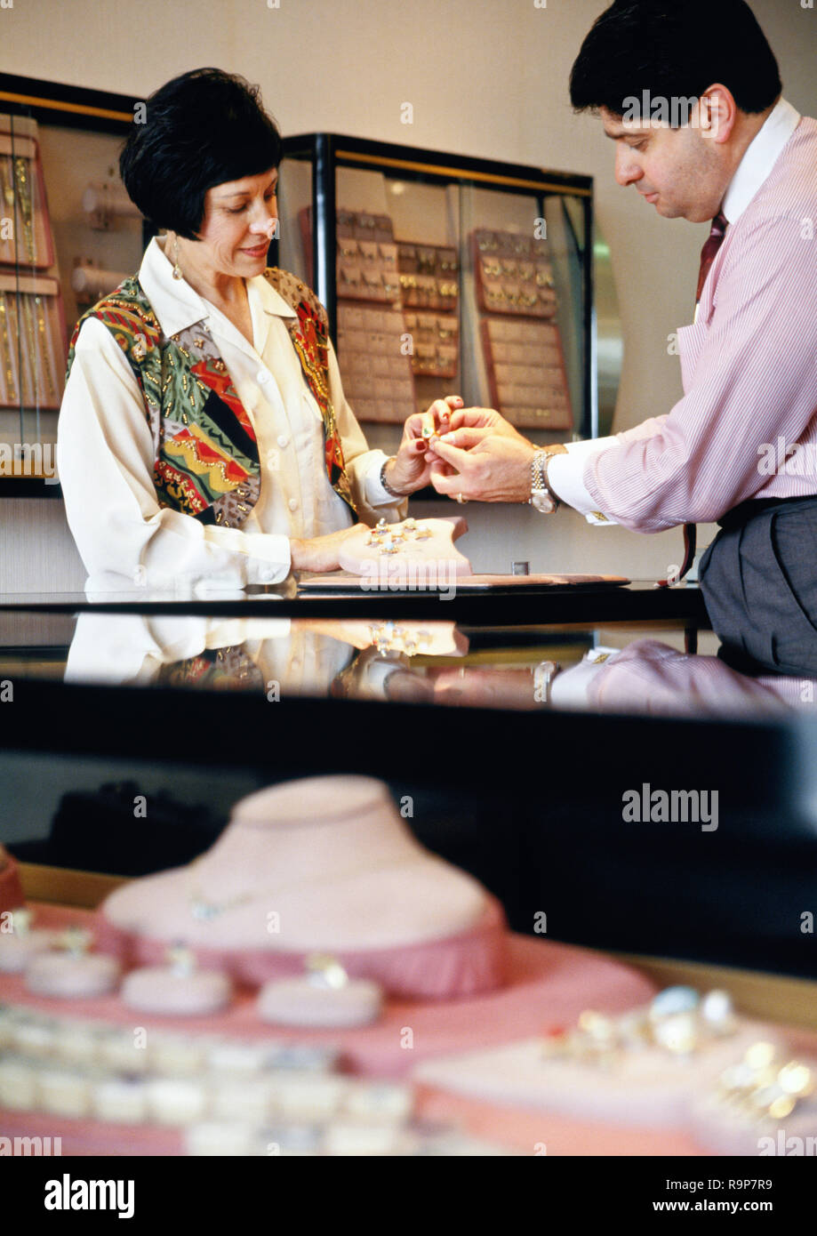 Jewelry store owner is showing a ring to female customer, USA Stock ...