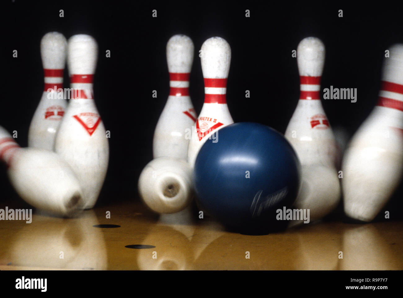 Action image of a bowling ball striking pins in a bowling alley, USA ...
