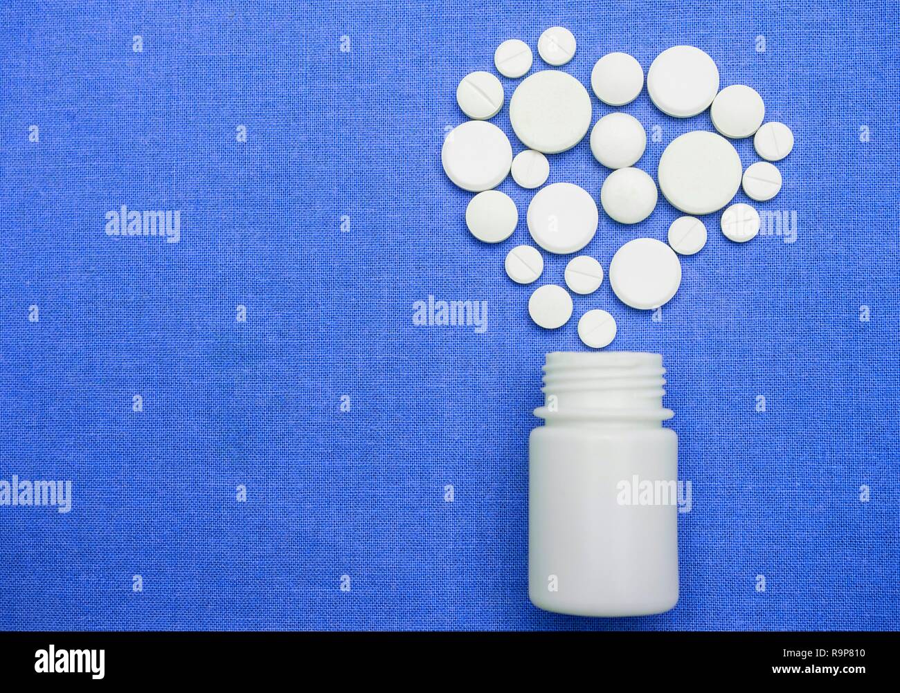 Pills coming out white pot forming an isolated heart in green ...