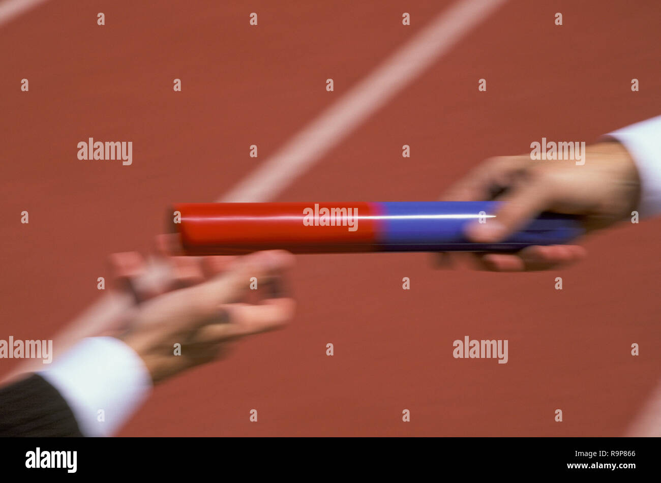 Businessmen passing the baton on running track, USA Stock Photo - Alamy