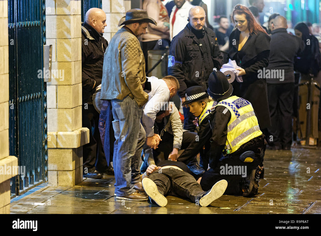Pictured: Police and bystanders see to a man that collapsed on the ...