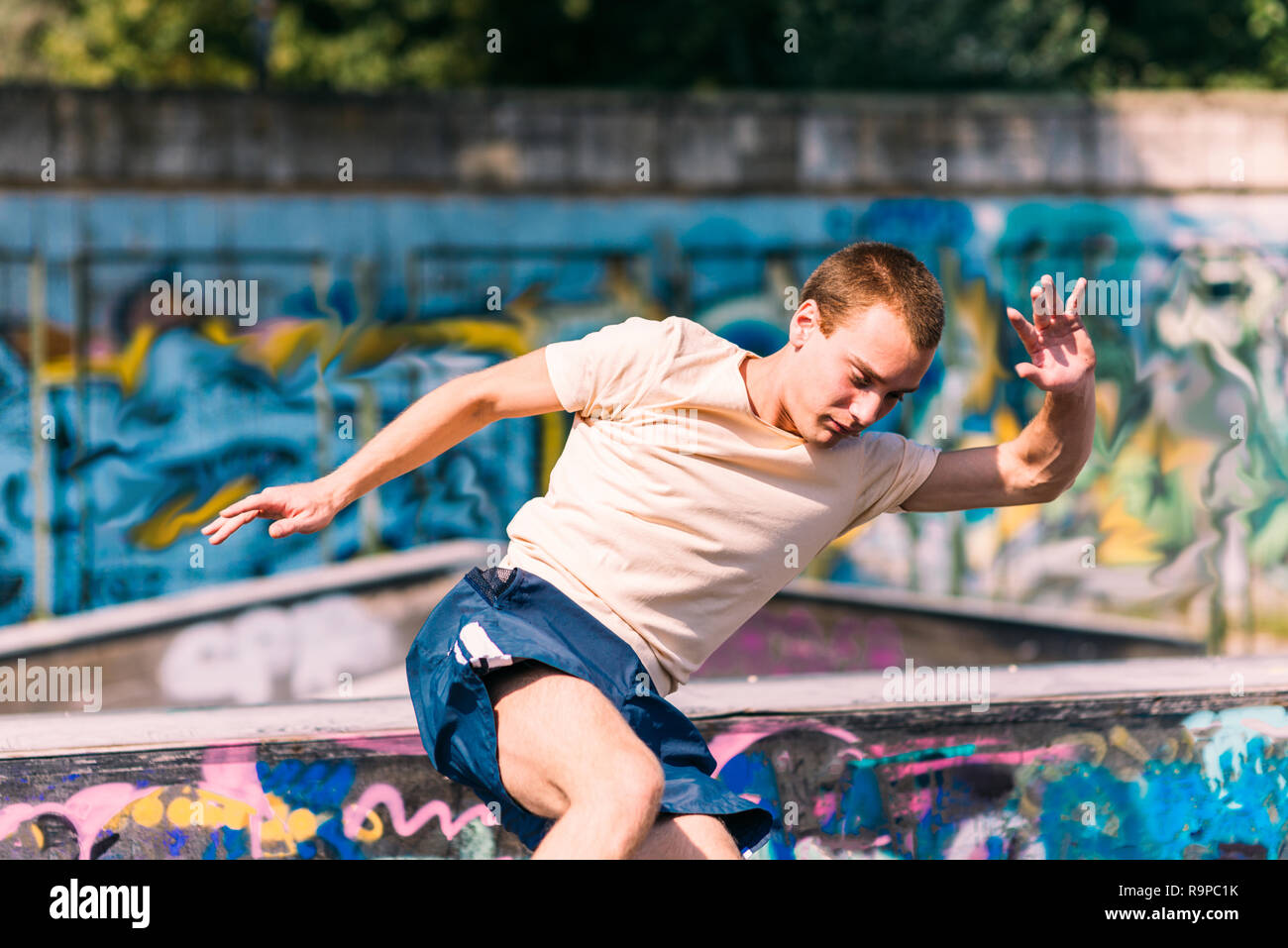 Sportsman jumping over obstacles while exercising Stock Photo - Alamy