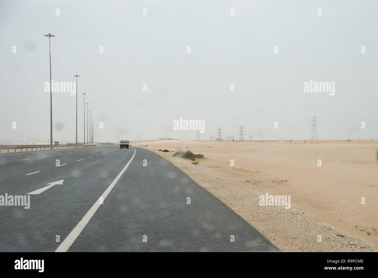Desert highway in Qatar with raindrops on car window Stock Photo - Alamy