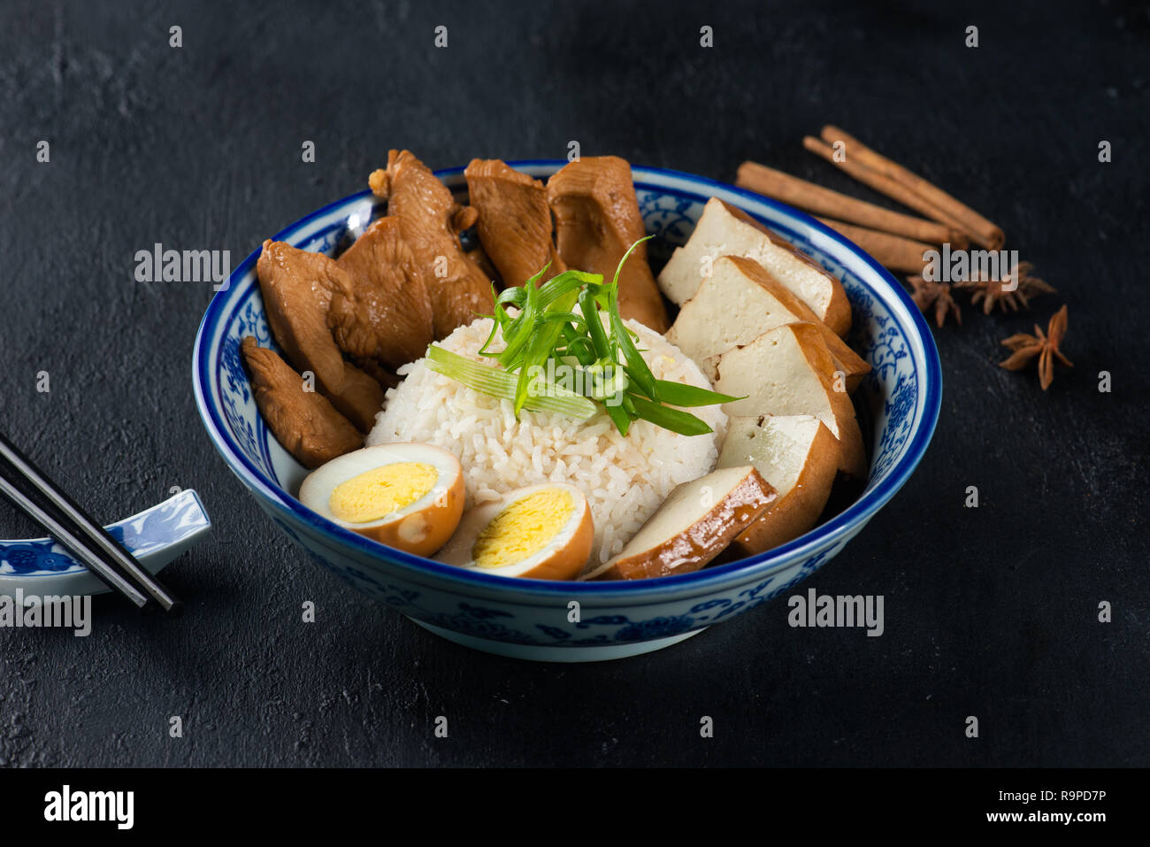chinese braised chicken over rice with boiled egg and tofu Stock Photo ...