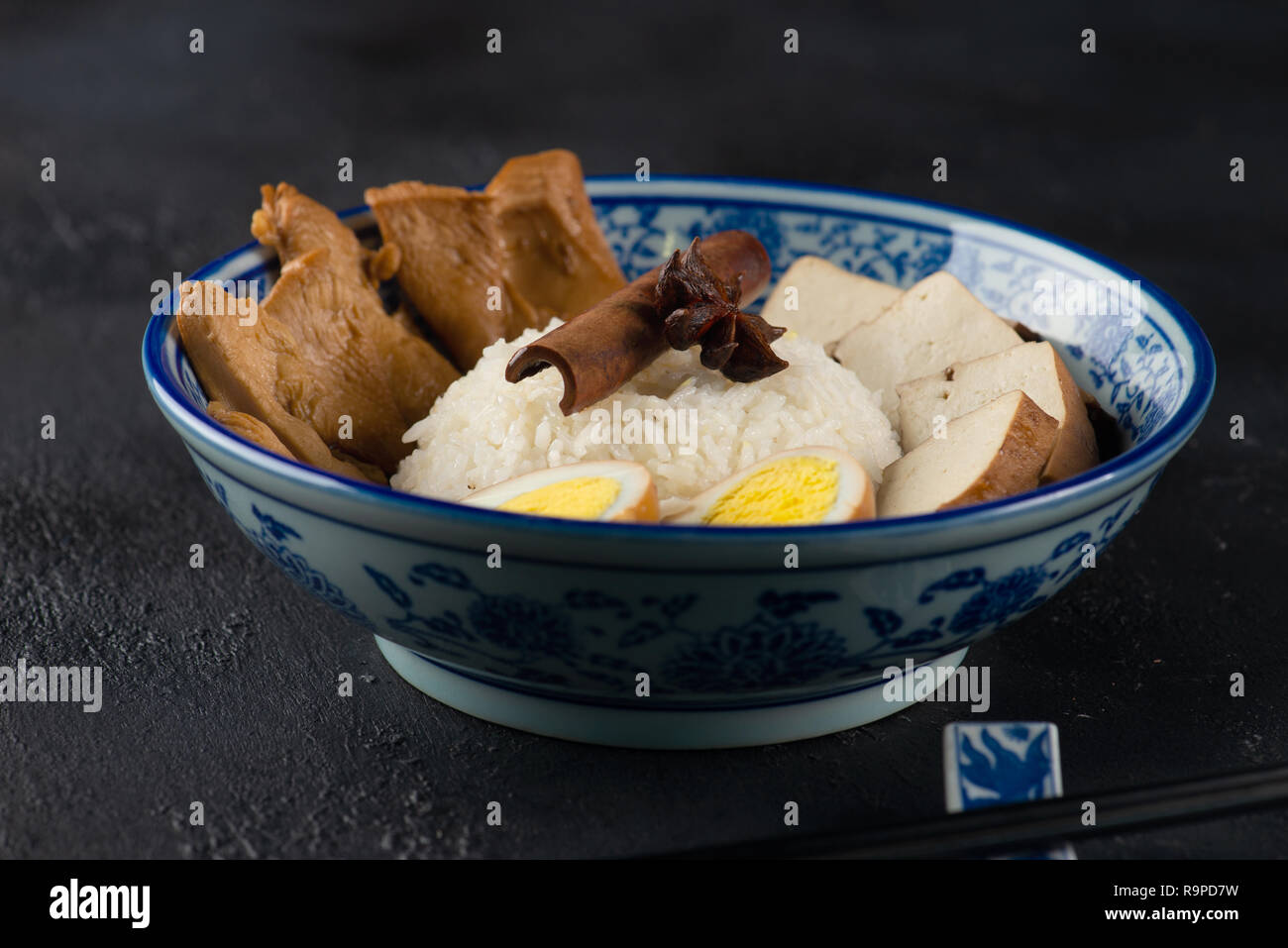 chinese braised chicken over rice with boiled egg and tofu Stock Photo ...