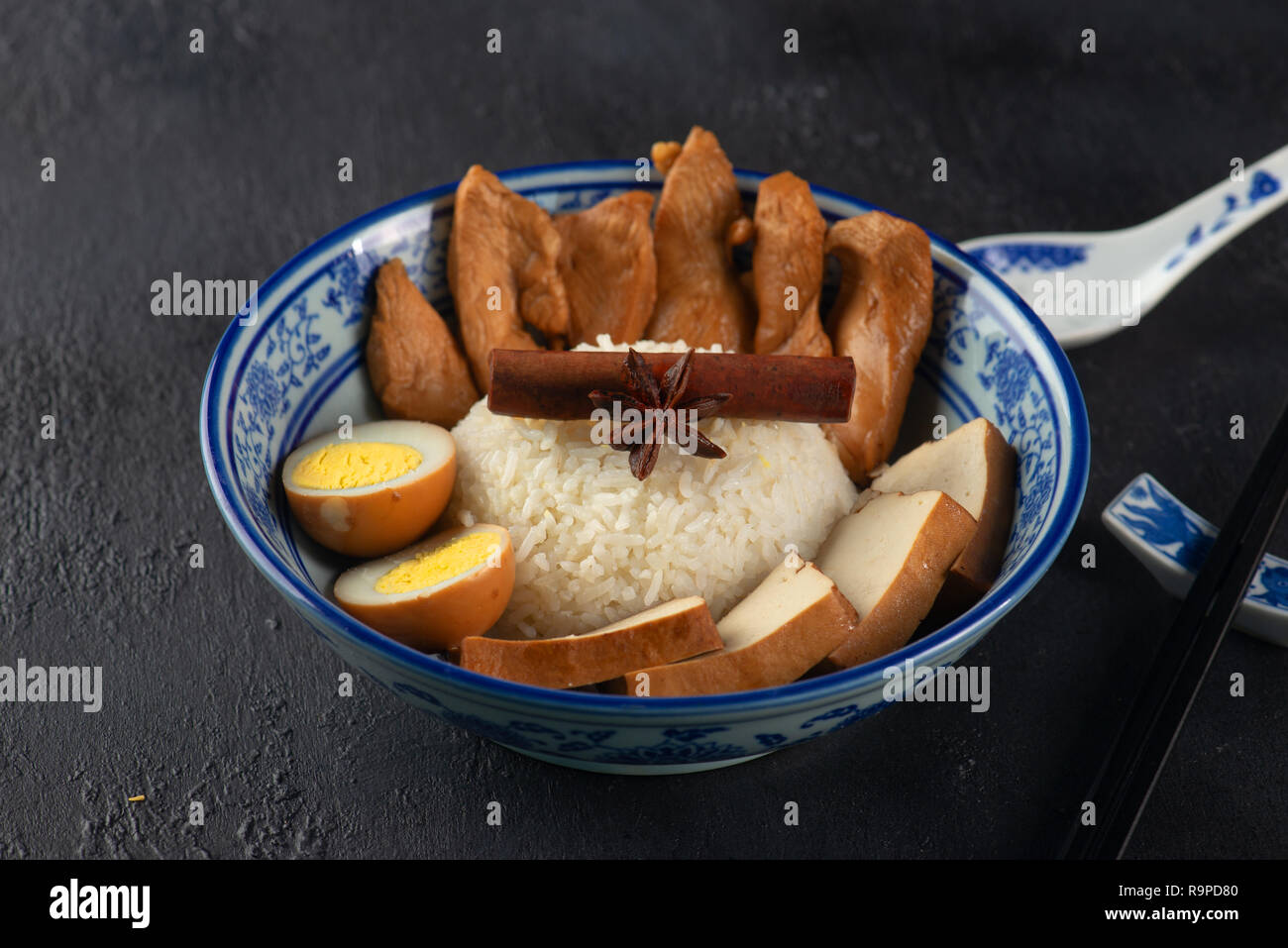 chinese braised chicken over rice with boiled egg and tofu Stock Photo ...
