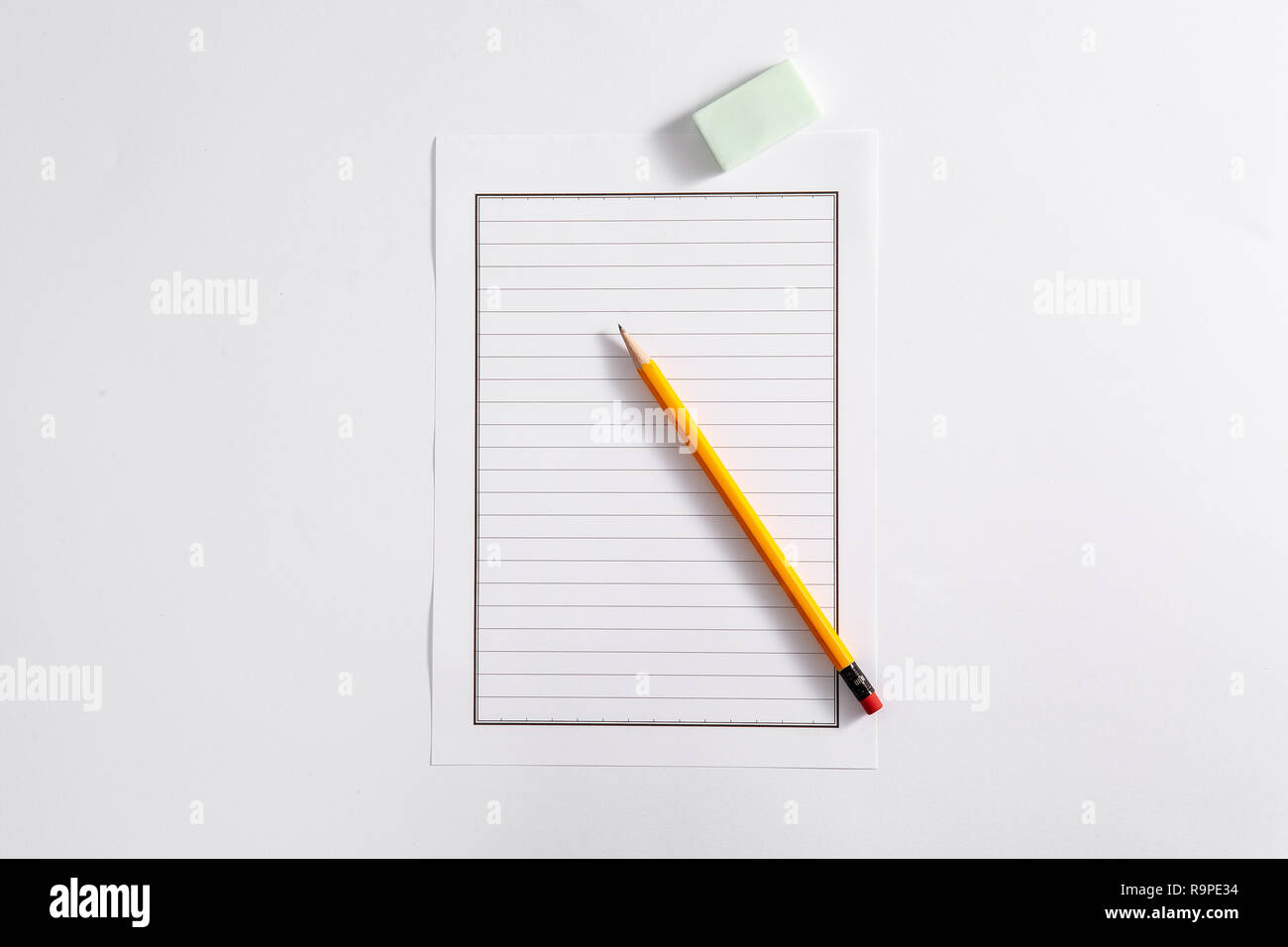 a letter paper, a pencil, and an eraser Stock Photo - Alamy