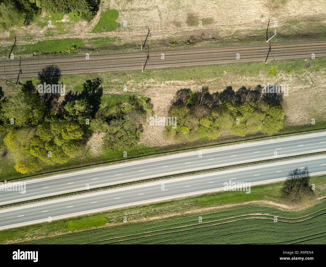 Top view. High-speed highway and railway. Green field and blue sky ...
