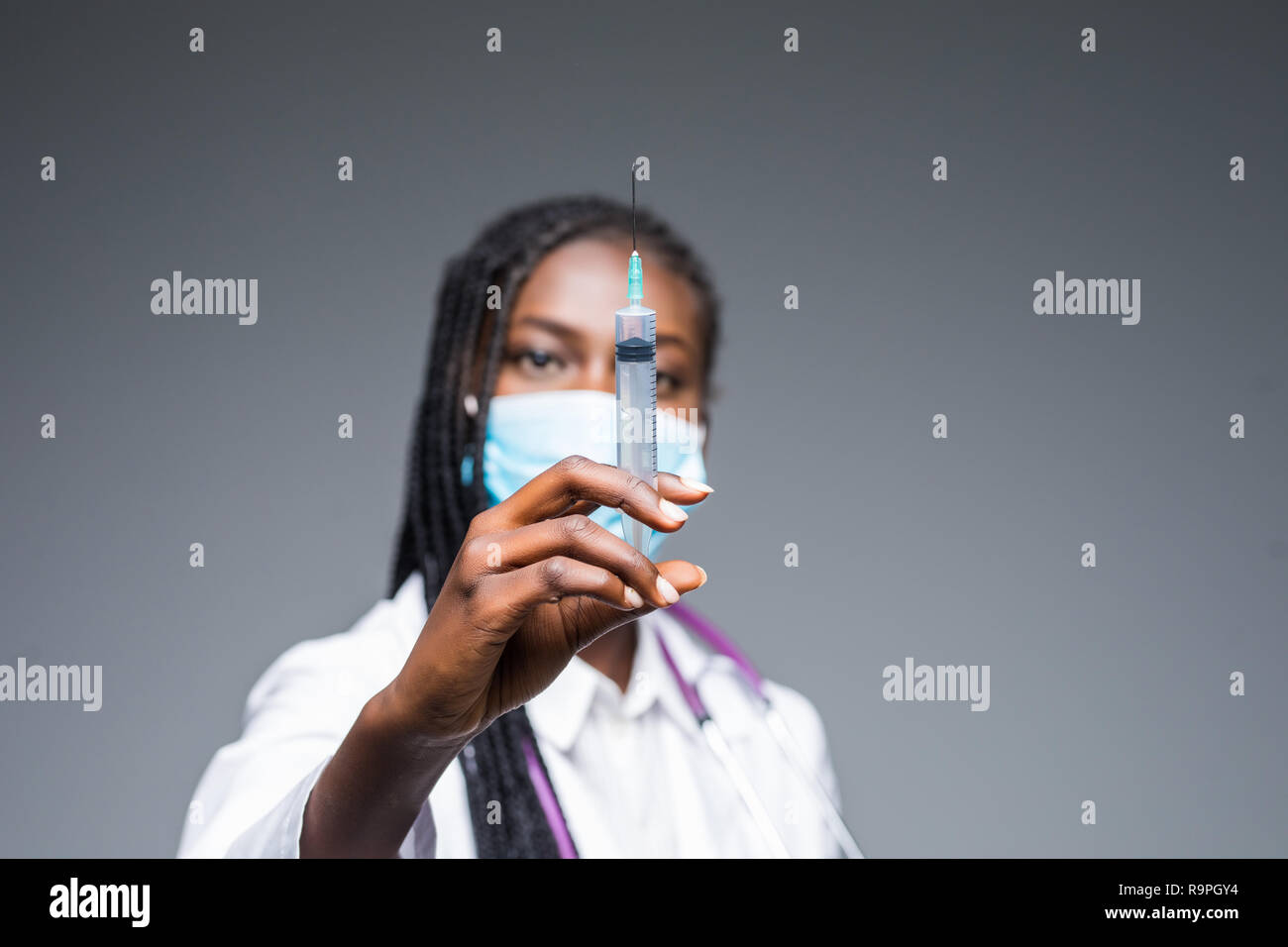 African american doctor holding injection isolated on white background ...
