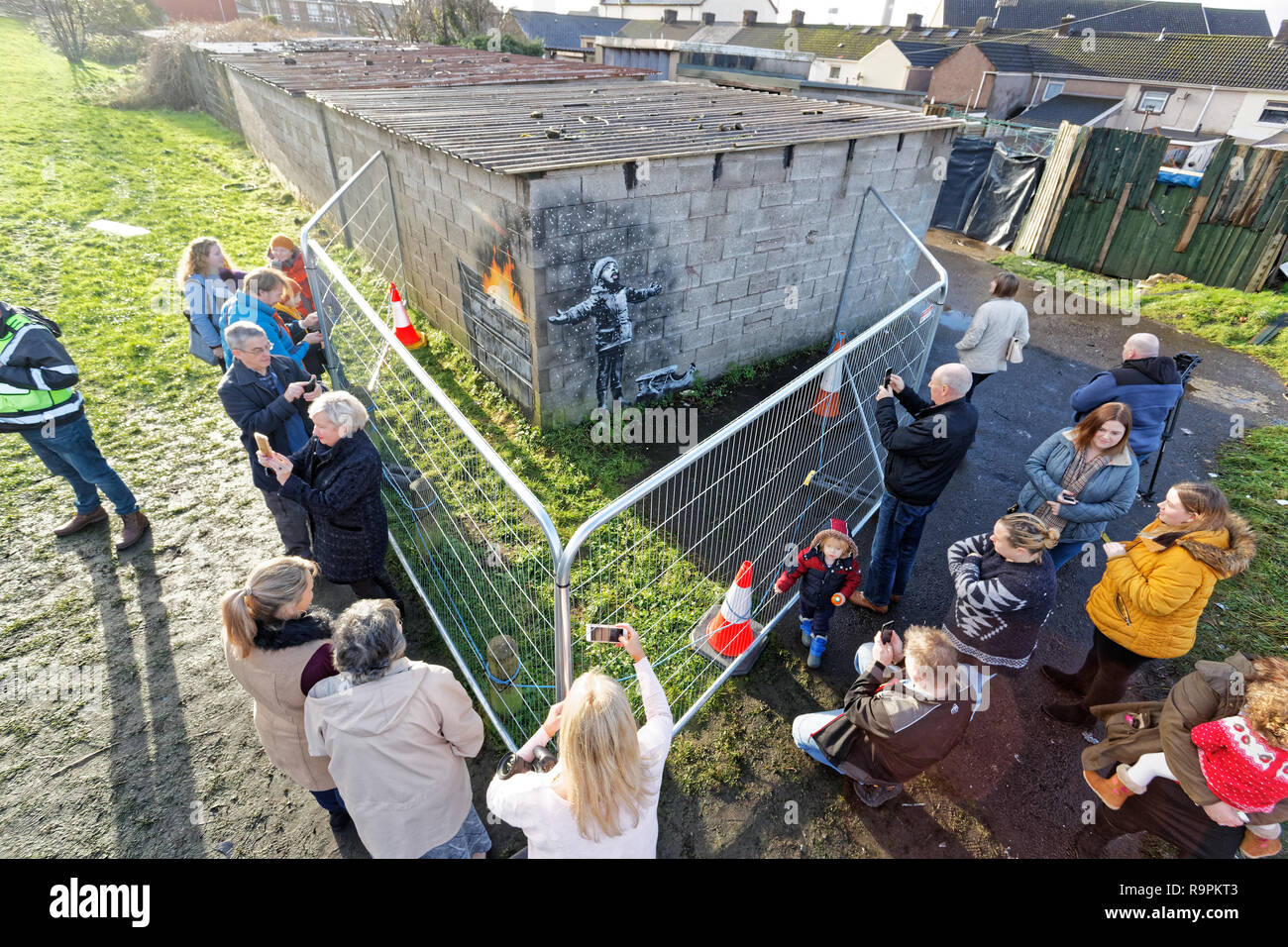 Pictured: People arrive to see and take pictures of the Banksy graffiti ...