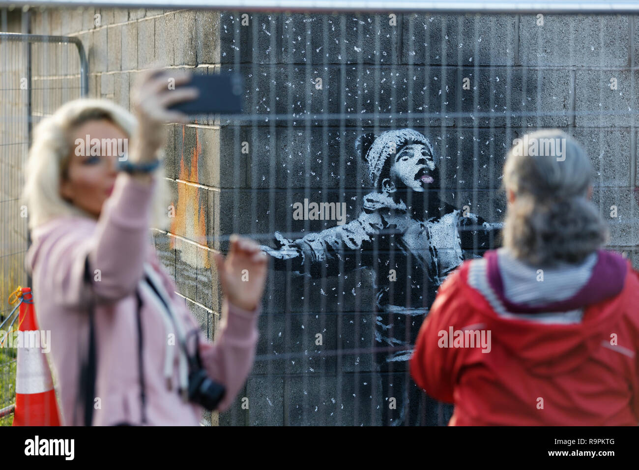 Pictured: People arrive to see and take pictures of the Banksy graffiti ...