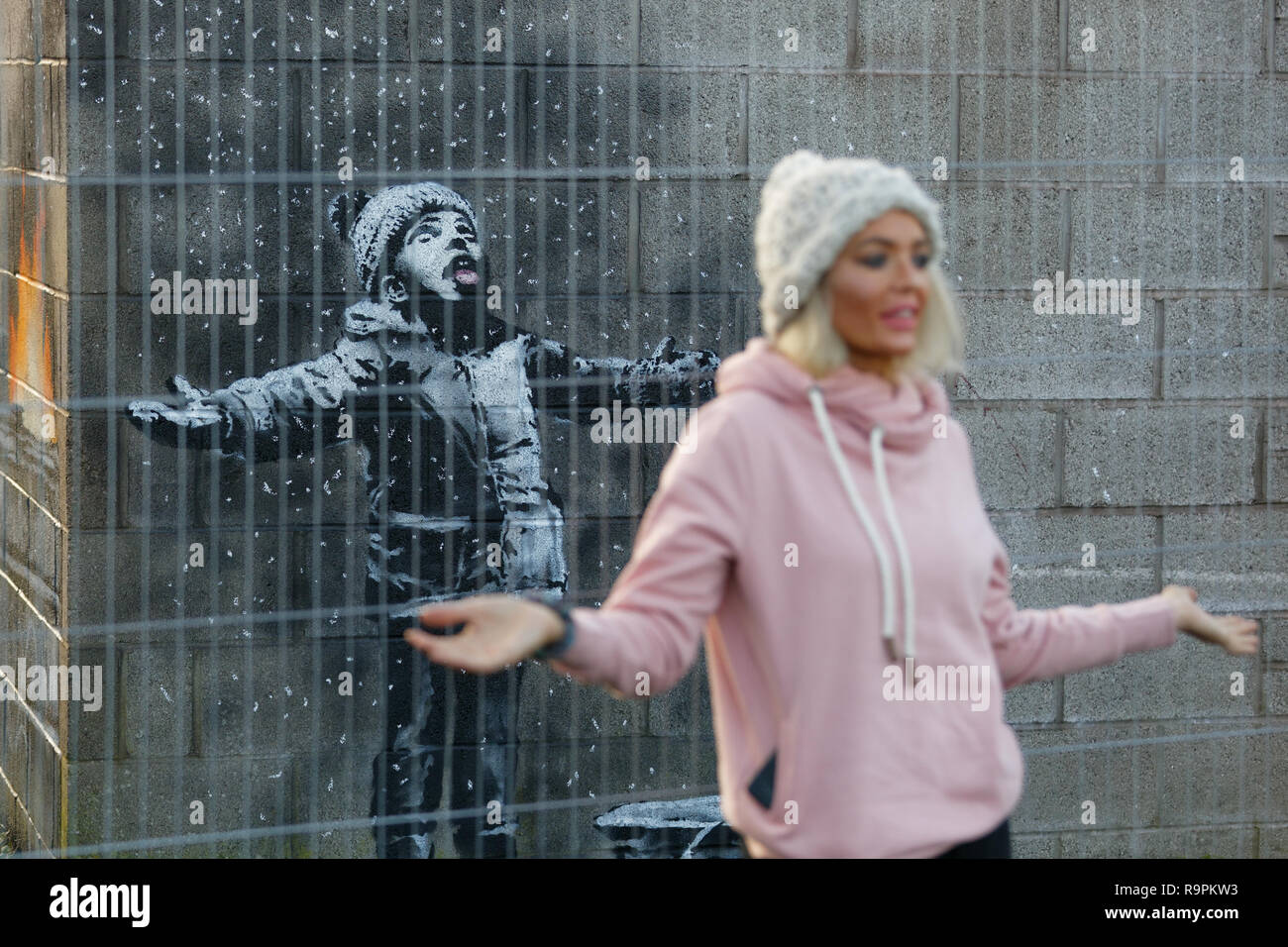 Pictured: People arrive to see and take pictures of the Banksy graffiti ...