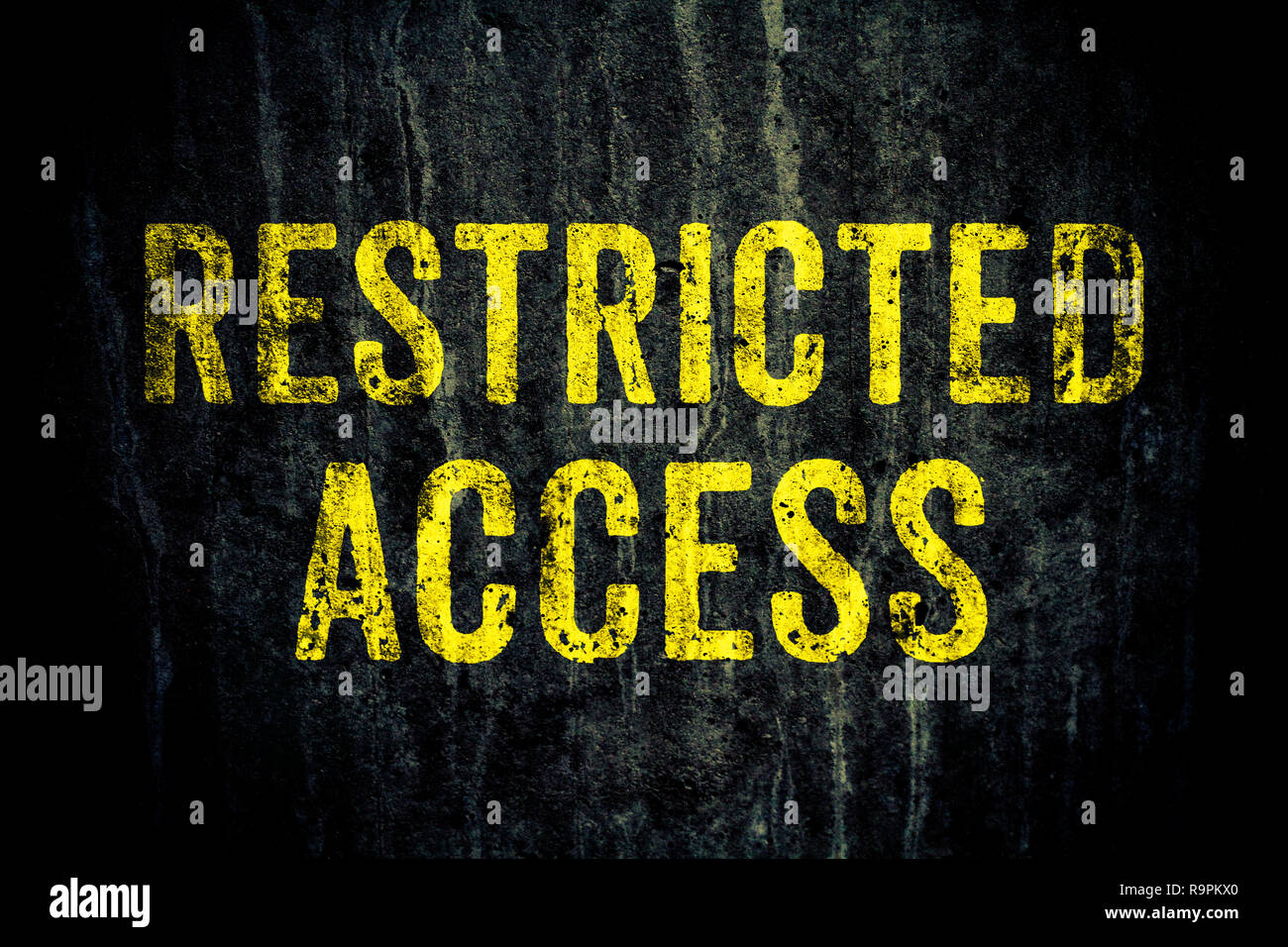 Restricted access warning danger sign in yellow letters painted over ...