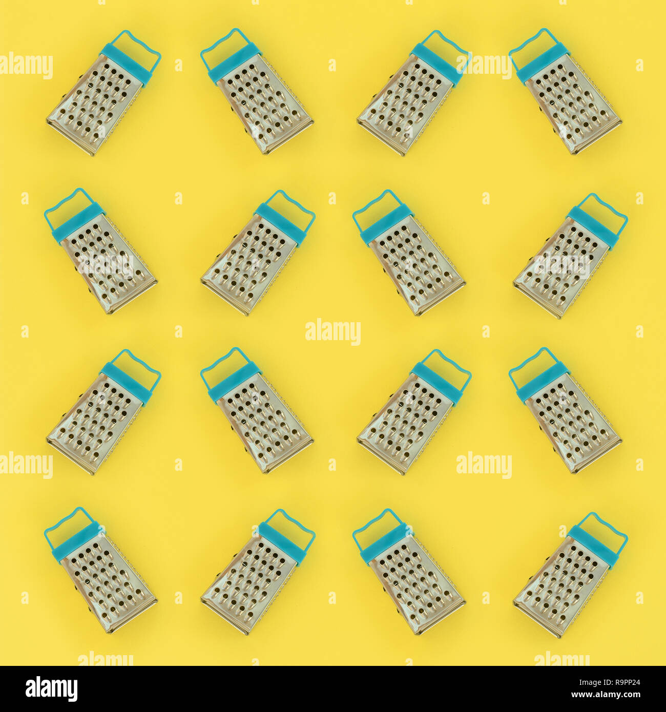 Small stainless steel graters lies on a pastel colored paper. Kitchen ...