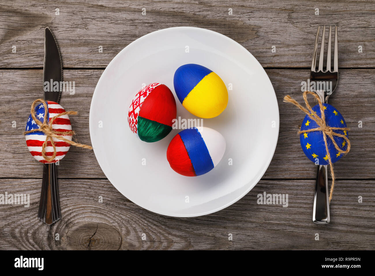 Three Easter eggs painted in the color of the flags of Russia, Ukraine ...