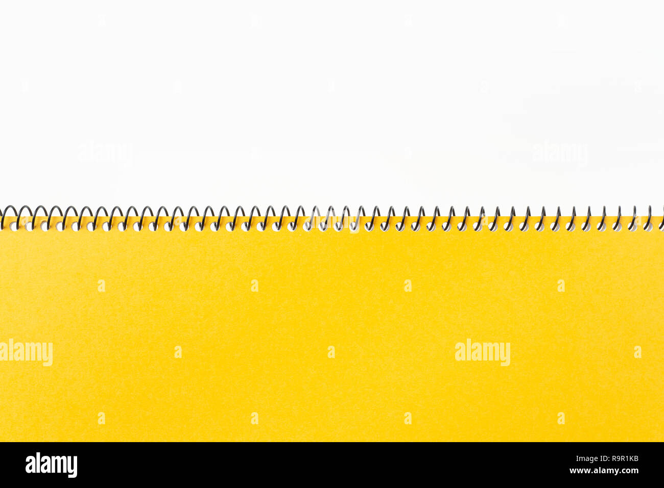 Design concept - Top view of yellow spiral notebook with geometric ...
