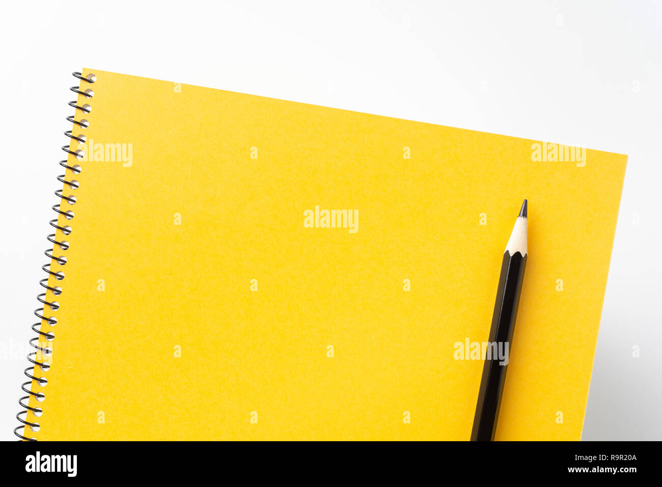 Design concept - Top view of yellow spiral notebook with geometric ...