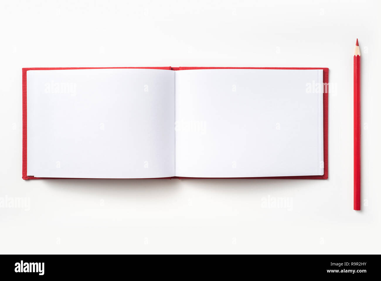 Design concept - Top view of red hardcover notebook and pencil isolated ...
