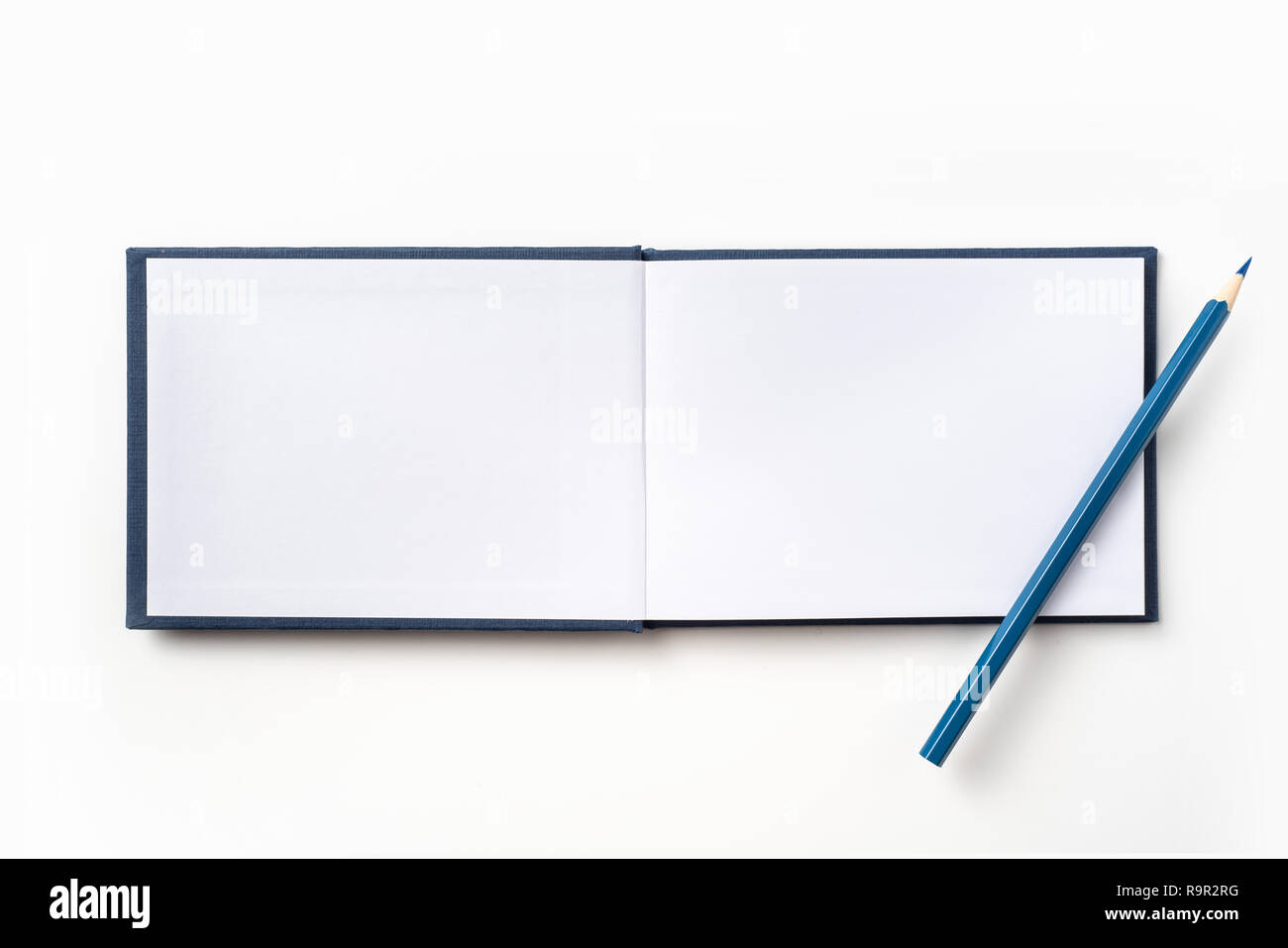 Design concept - Top view of blue hardcover notebook and pencil ...