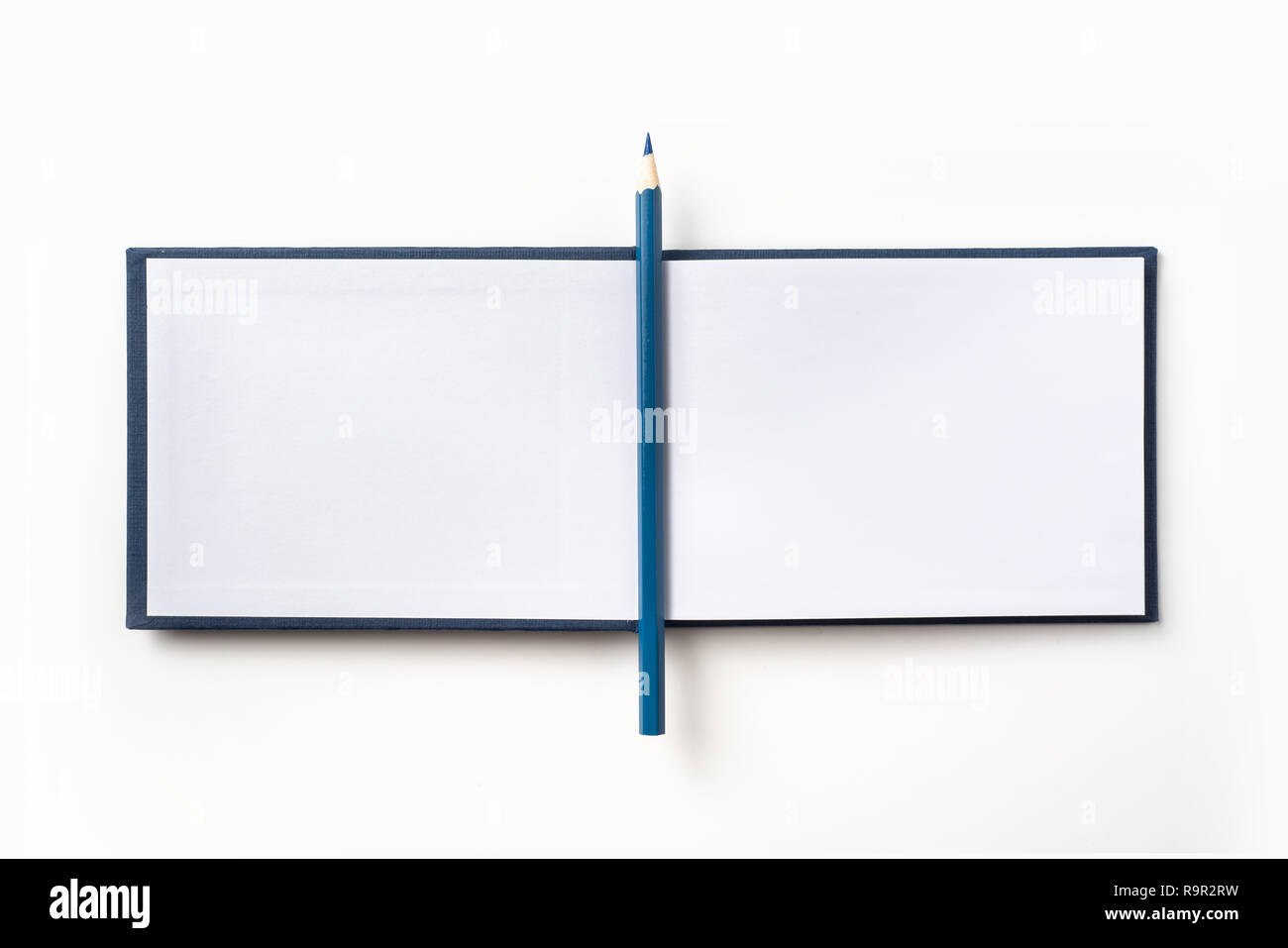 Design concept - Top view of blue hardcover notebook and pencil ...