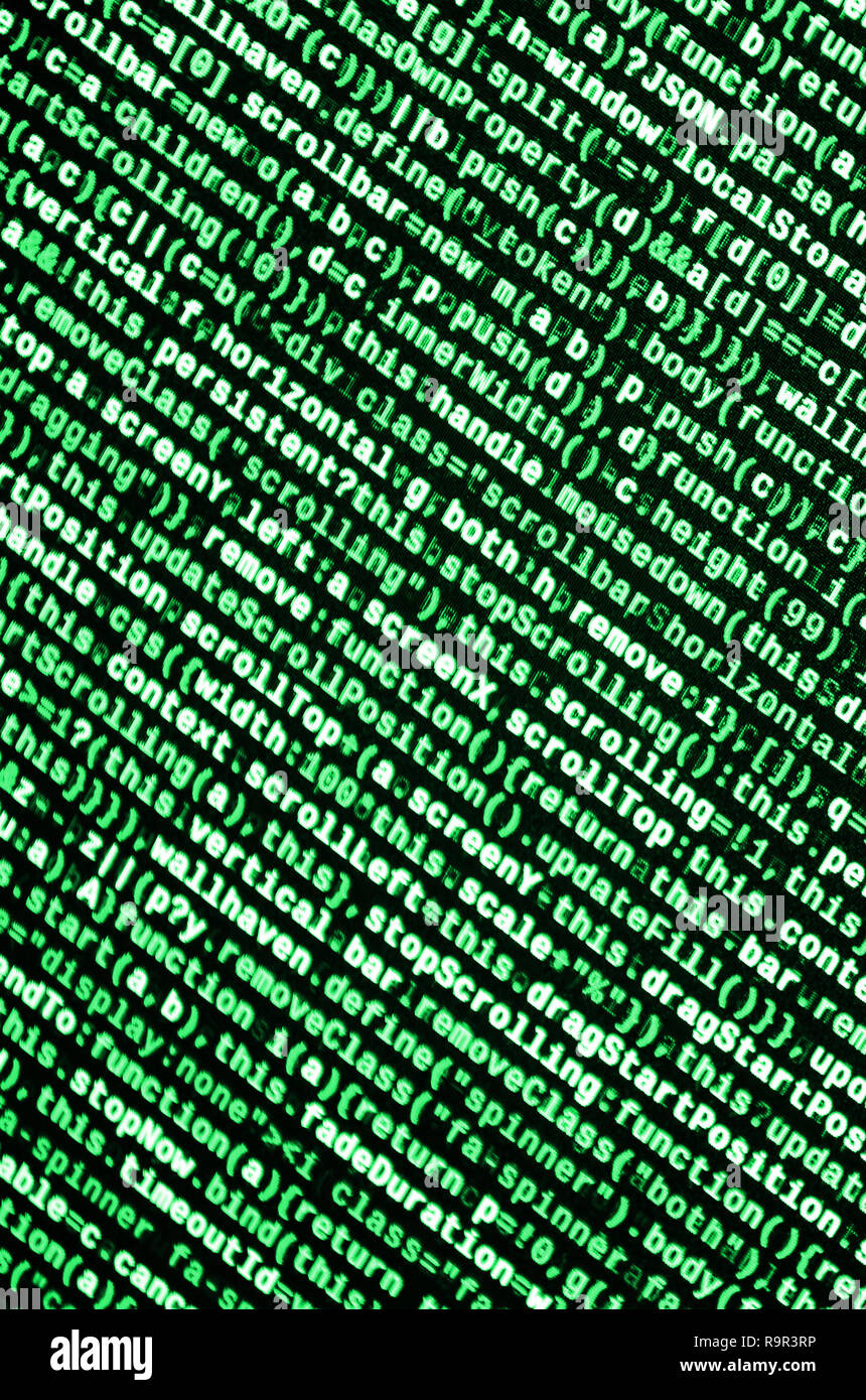 Writing programming code on laptop. Digital binary data on computer screen. Project managers ...