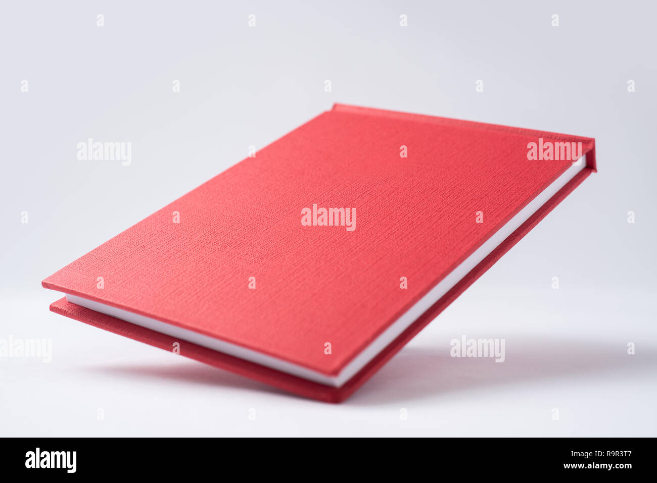 Design concept - Top view red hardcover notebook isolated on background ...
