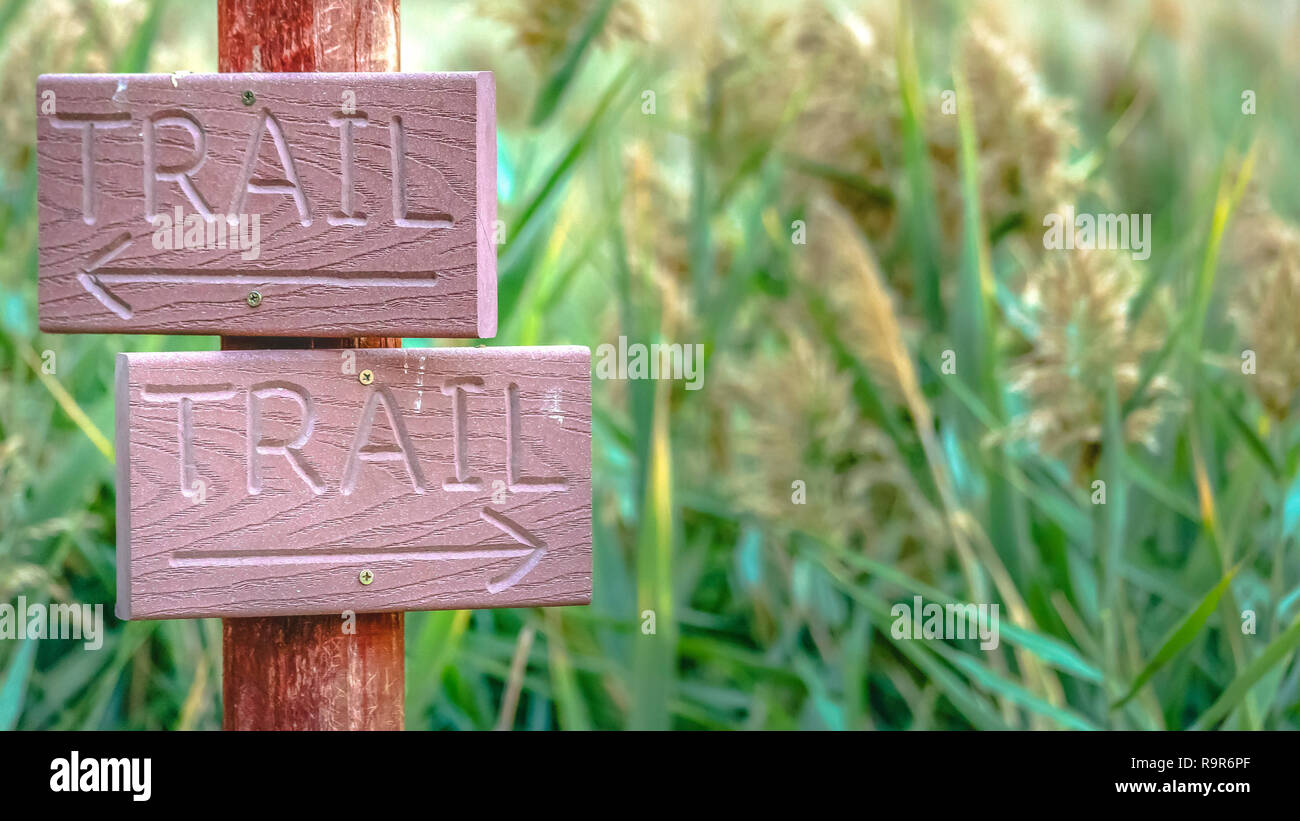 Wooden trail signs with grasses in the background Stock Photo - Alamy