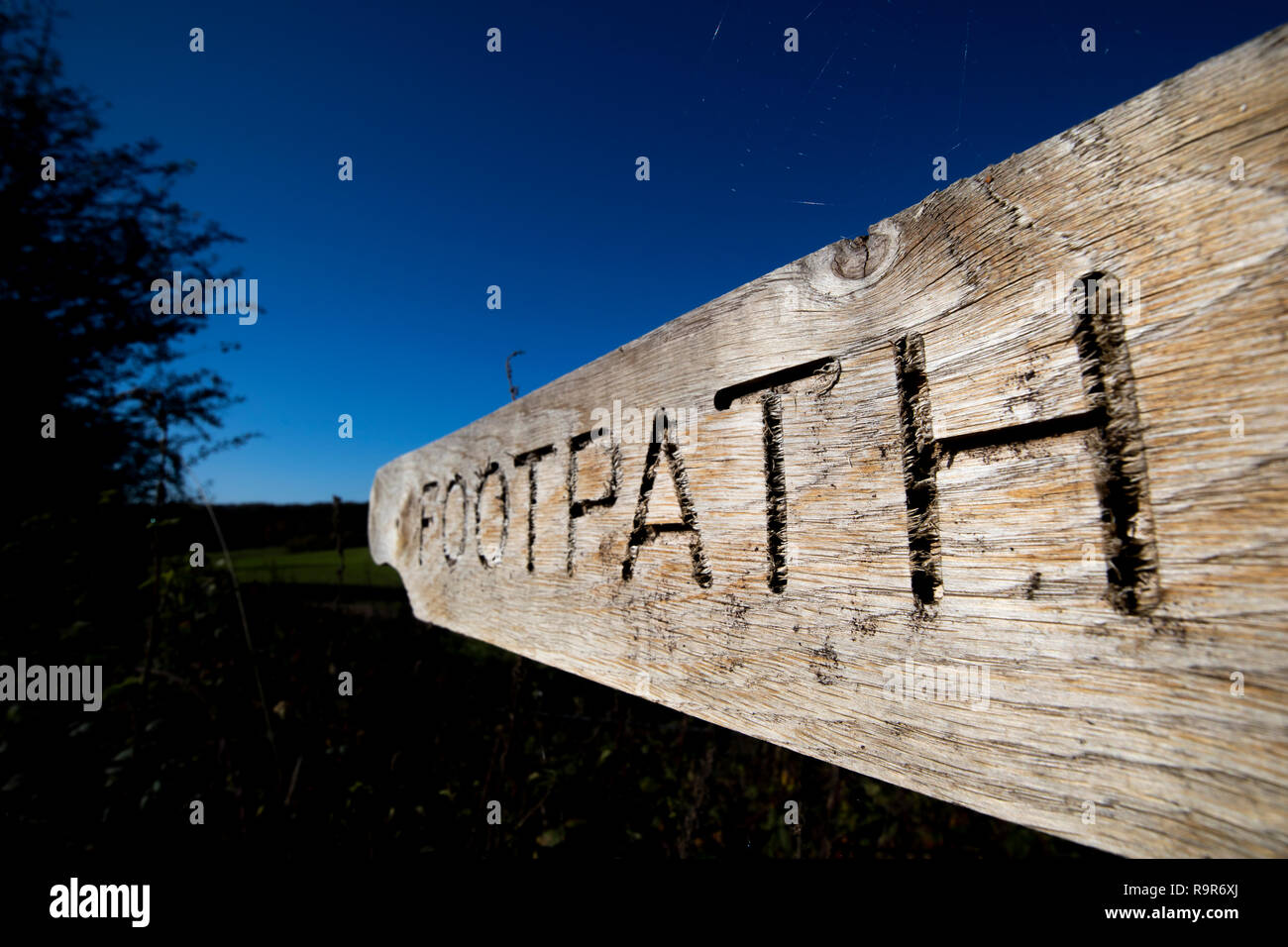 Wooden footpath sign showing right of pedestrian way across farmland in ...