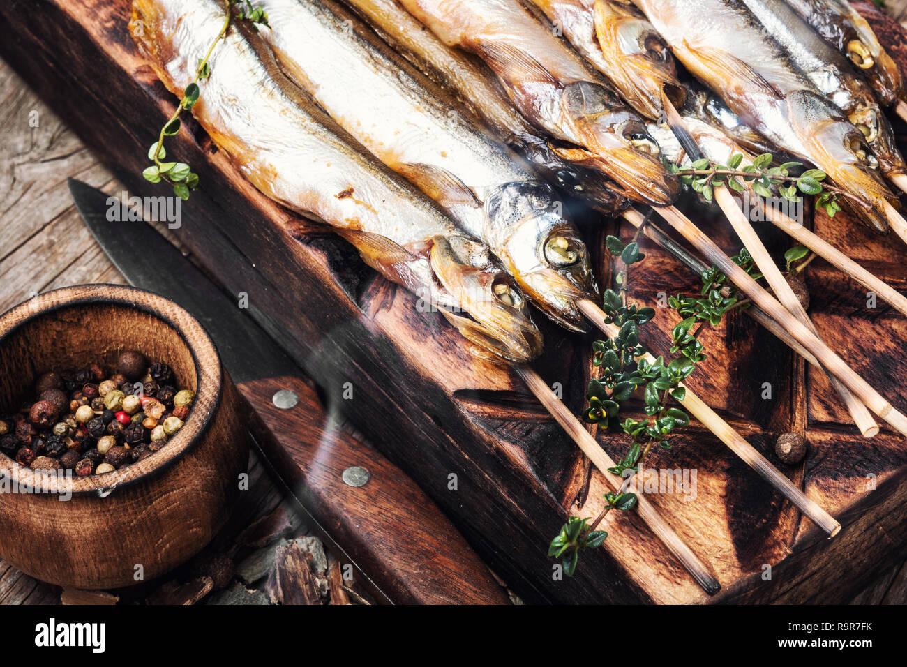 Smoked fish with spices.Cold smoked fish.Smoked capelin.Food industry ...