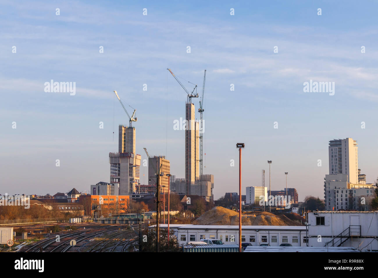The changing skyline of Woking, Surrey: railway tracks lead into tower ...