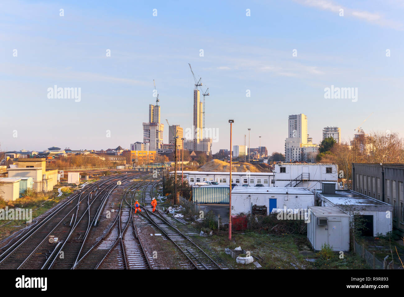The changing skyline of Woking, Surrey: railway tracks lead into tower ...
