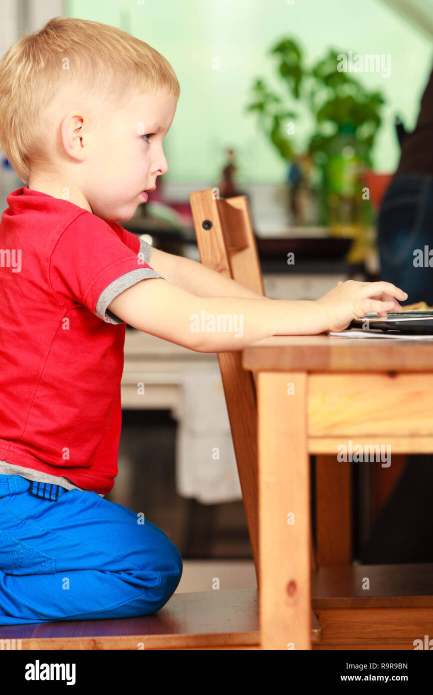 Children and technology, spending free time online concept. Little boy ...