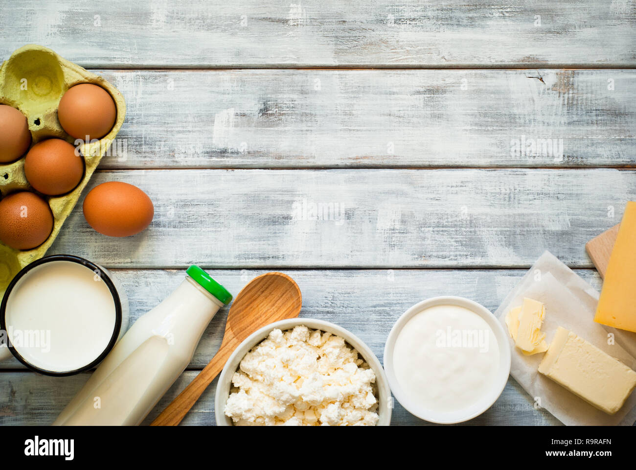 Dairy products on wooden table. Cottage cheese, Sour cream, milk ...
