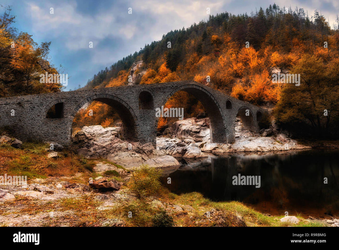 Devil's bridge, Bulgaria. Ancient stone bridge over Arda river, autumn ...