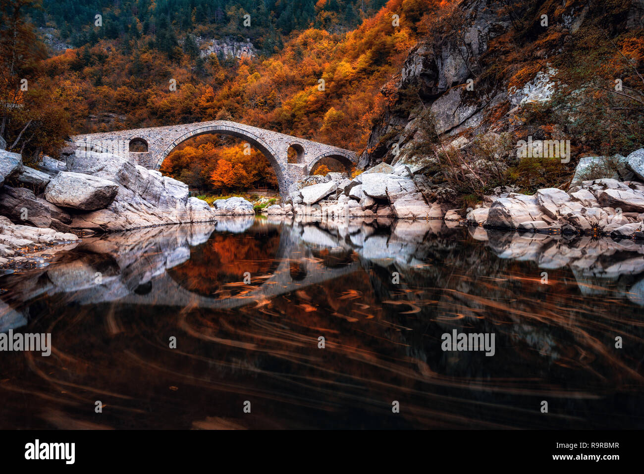 Devil's bridge, Bulgaria. Ancient stone bridge over Arda river, autumn ...