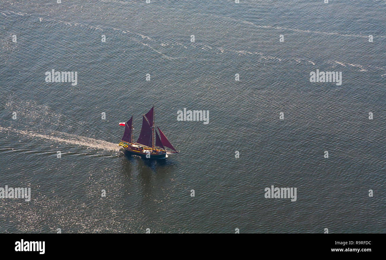 Aerial picture, large sailboat goes to sea under sail. View from above ...