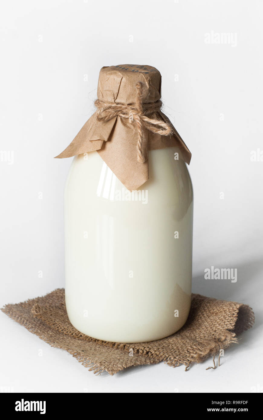 Old fashioned Bottle with milk isolated on white Stock Photo - Alamy