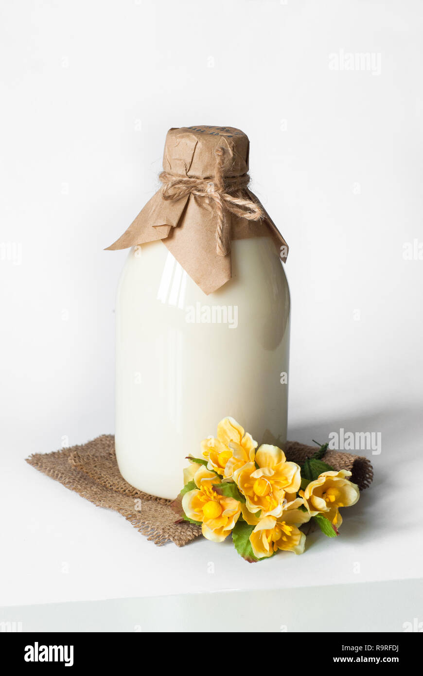 Old fashioned Bottle with milk isolated on white Stock Photo - Alamy