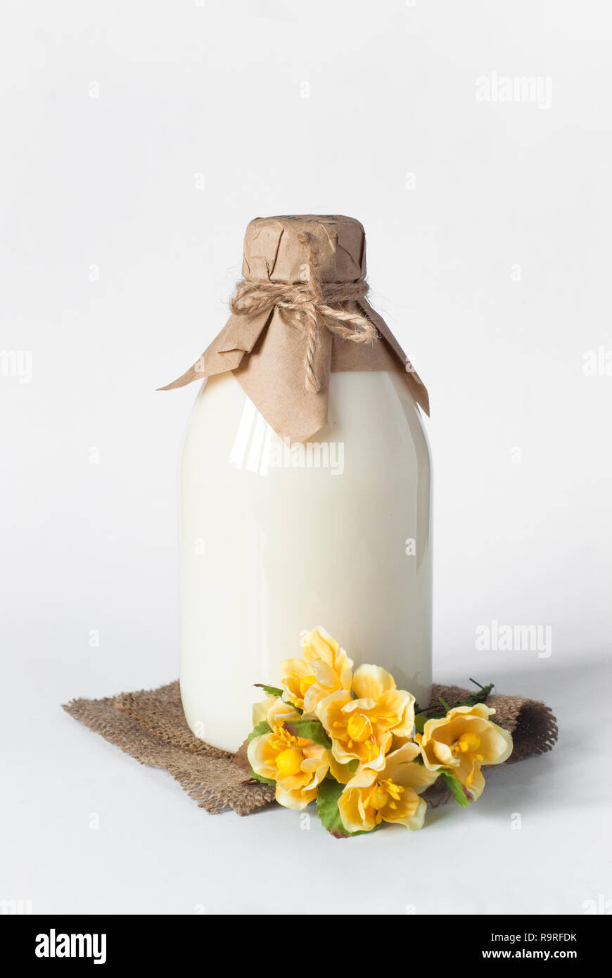Old fashioned Bottle with milk isolated on white Stock Photo - Alamy