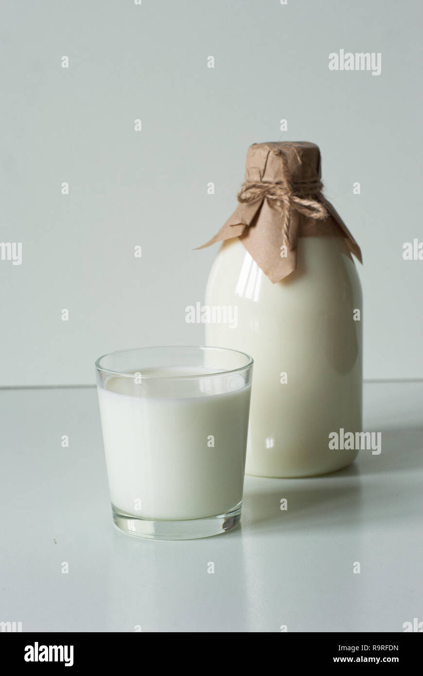 Old fashioned Bottle with milk isolated on white Stock Photo - Alamy