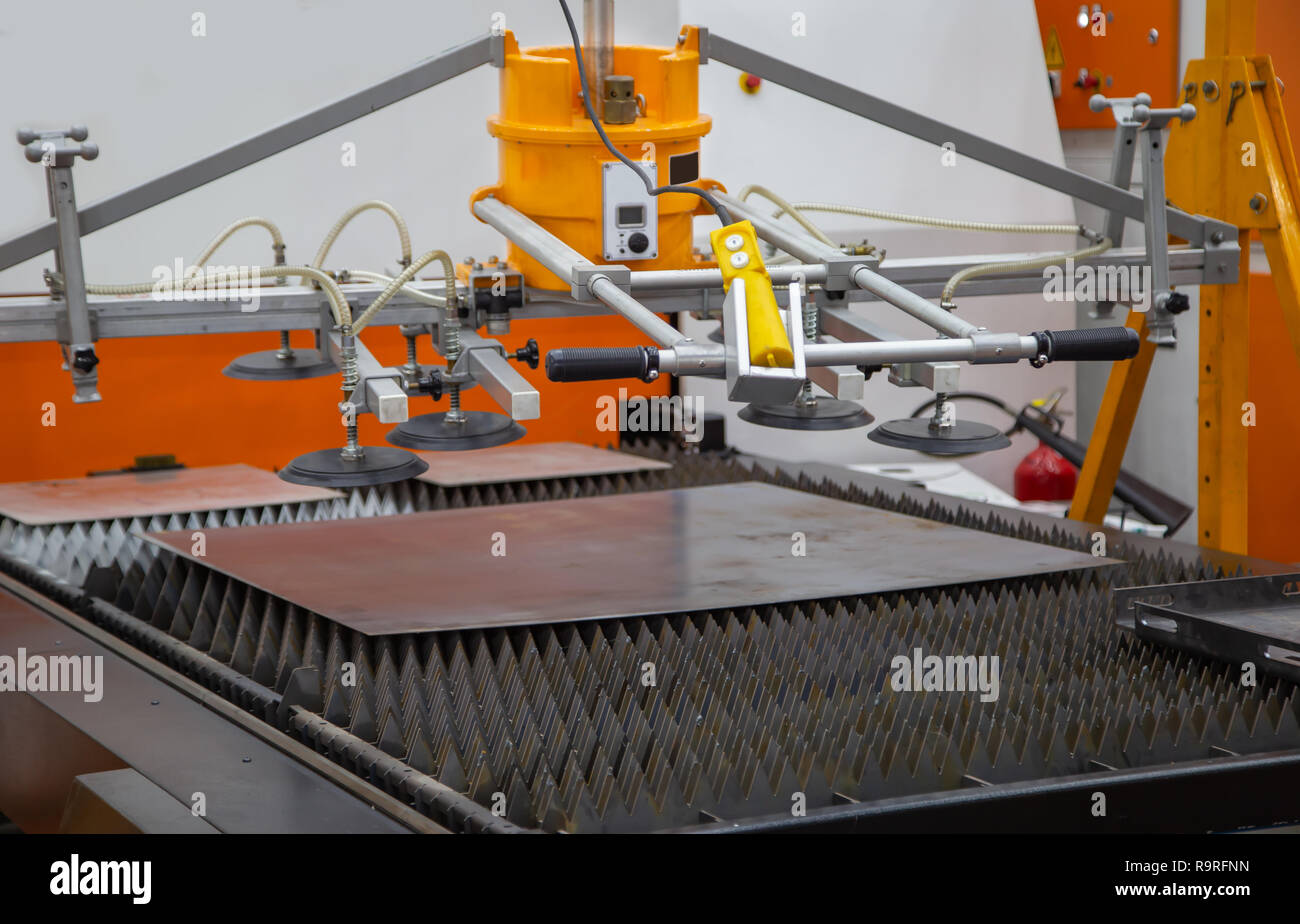 Mechanical vacuum metal sheet lifter loading to production line Stock ...